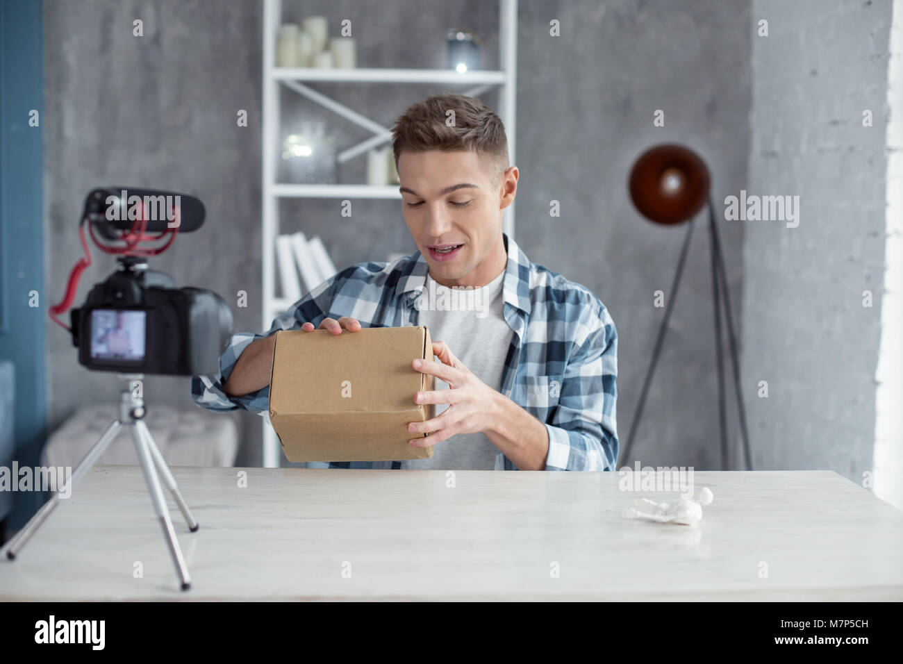 Happy young man opening his box Stock Photo - Alamy