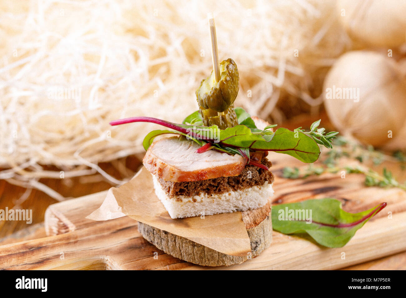 Canape with boiled pork on a wooden background. Rustic. Close-up Stock ...