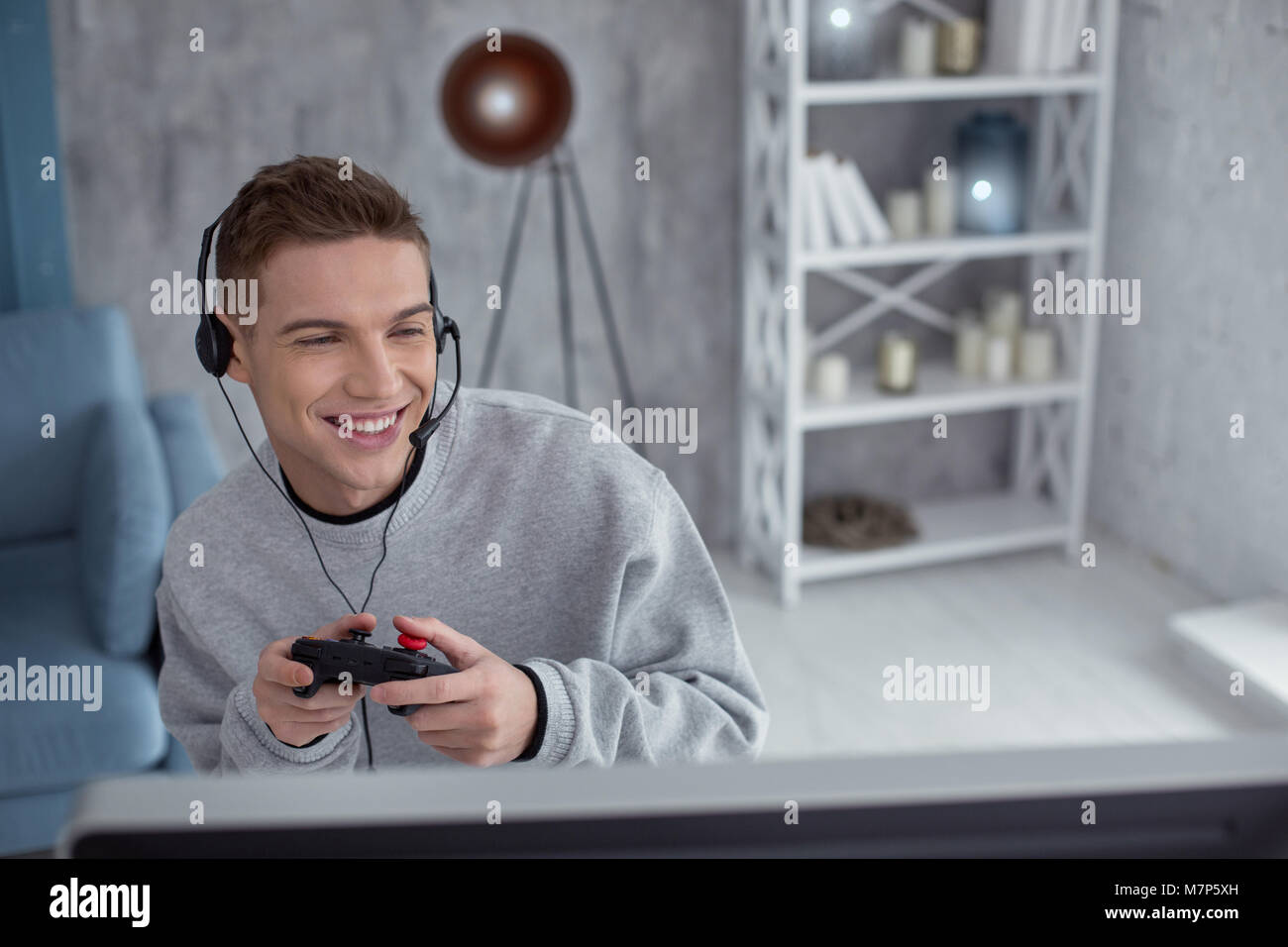 Happy teenager playing a computer game Stock Photo - Alamy
