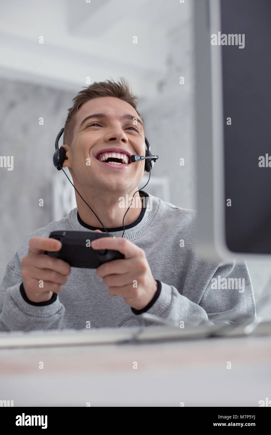 Excited teenager playing a computer game Stock Photo - Alamy