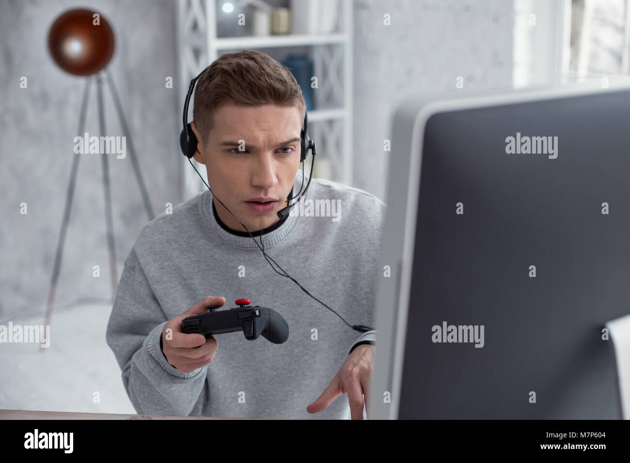 Concentrated teenager playing computer games Stock Photo - Alamy