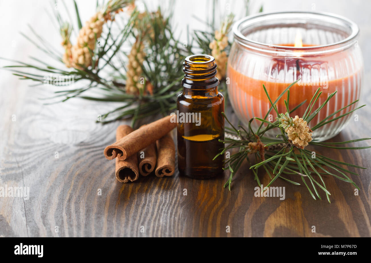 Coniferous tree essential oil and cinnamon stick Stock Photo - Alamy