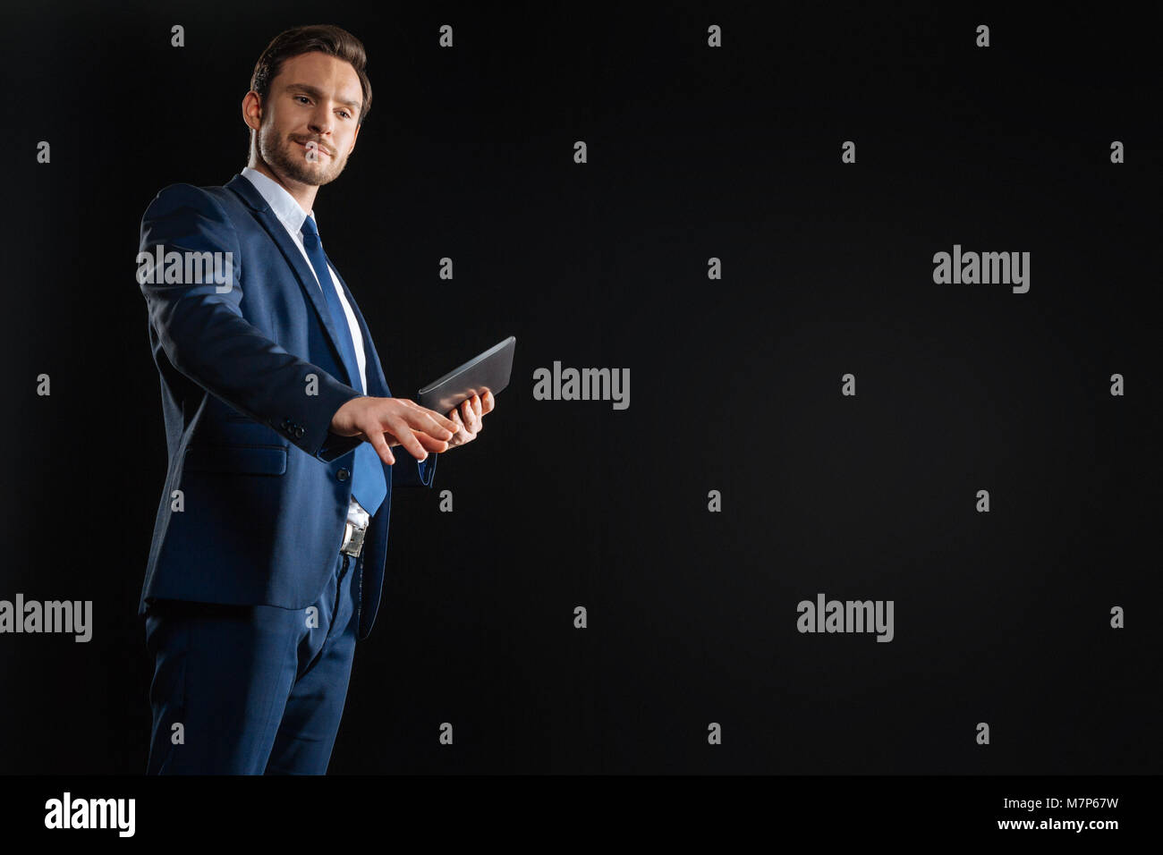 Pleasant clever man taking something and smiling Stock Photo - Alamy