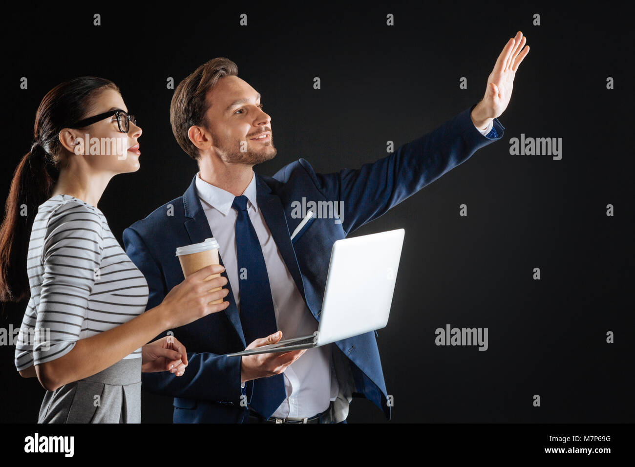 Satisfied interested employees looking up and working together Stock ...
