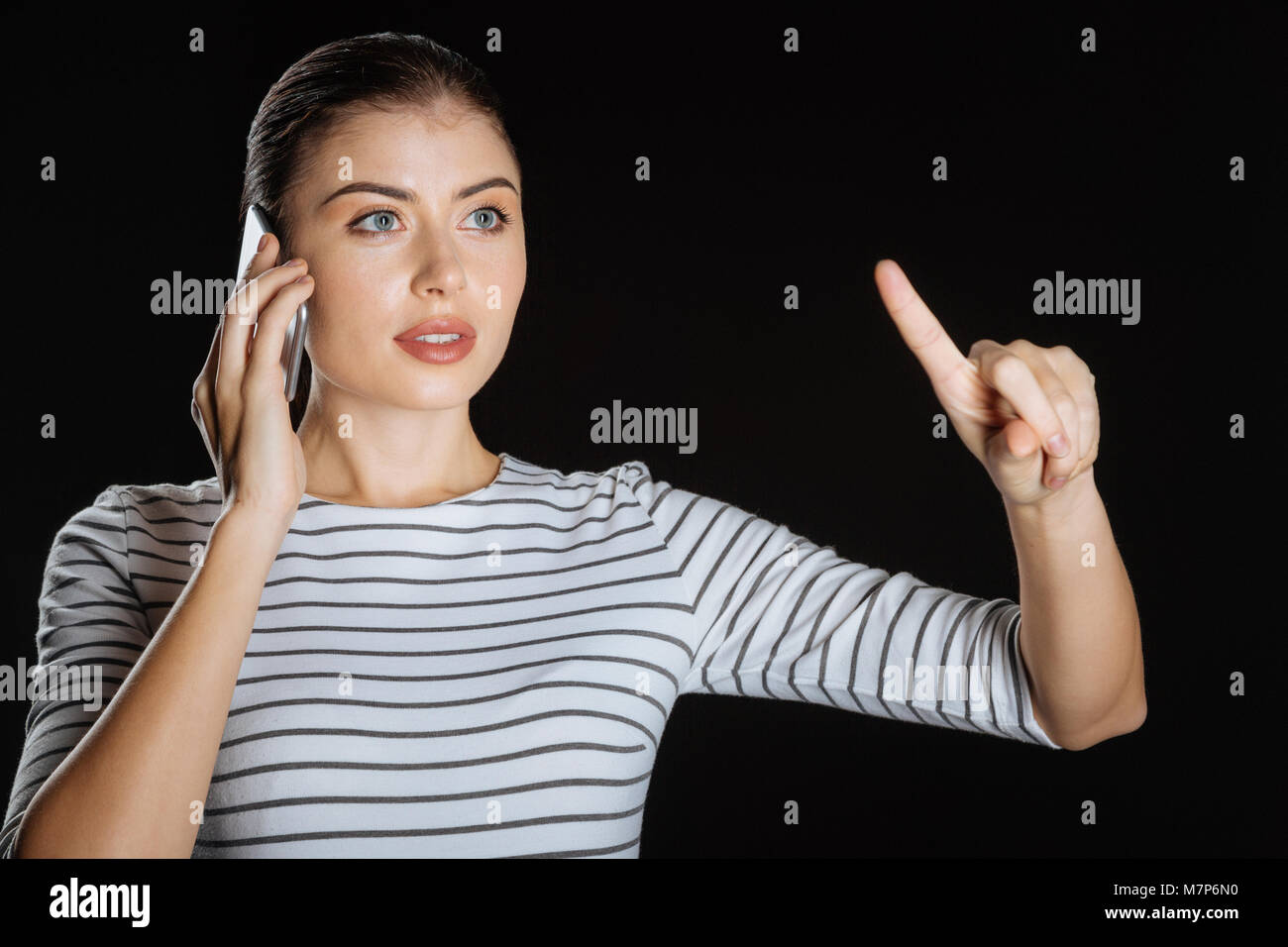 Busy interested woman pointing aside and having conversation Stock ...