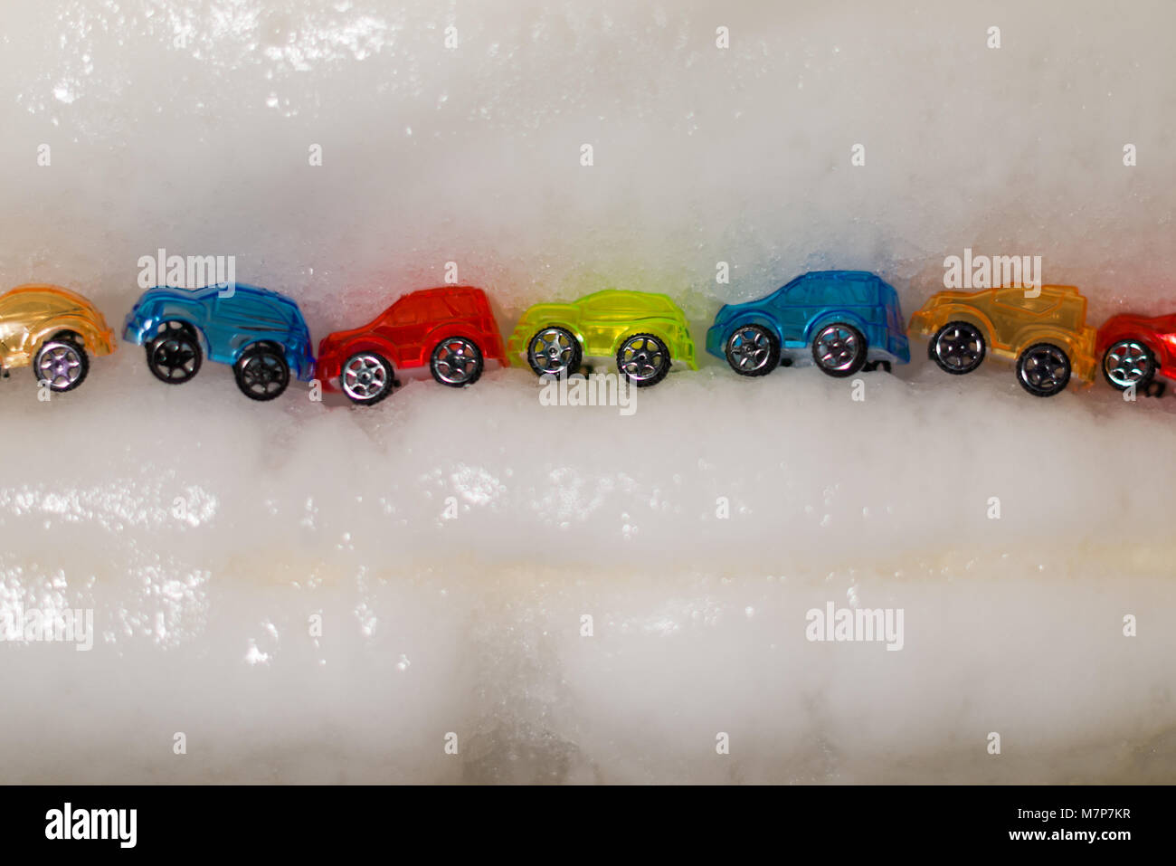 transparent coloured toy cars stuck in ice and snow Stock Photo - Alamy