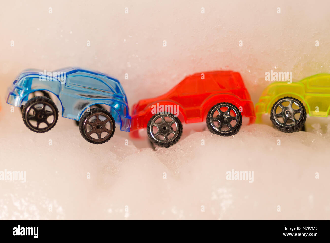transparent coloured toy cars stuck in ice and snow Stock Photo - Alamy