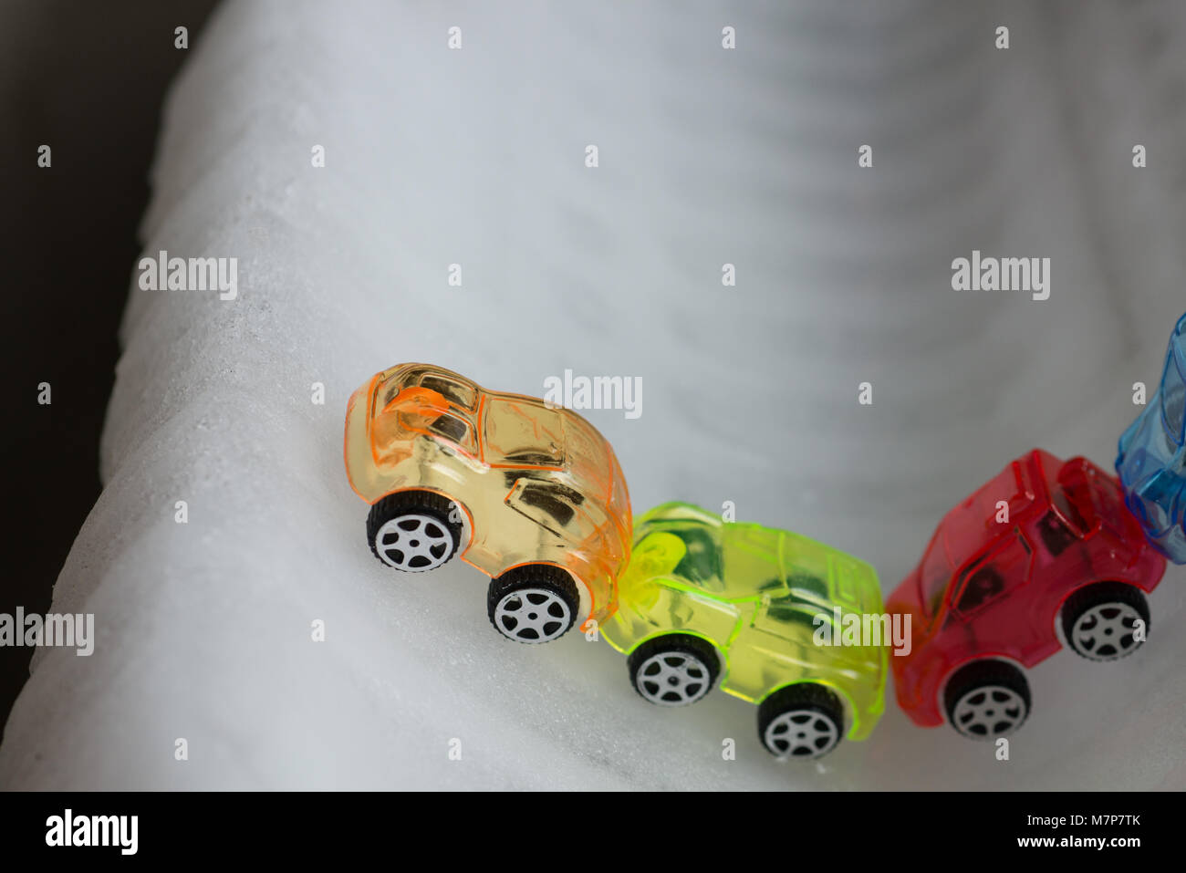 transparent coloured toy cars stuck in ice and snow Stock Photo - Alamy