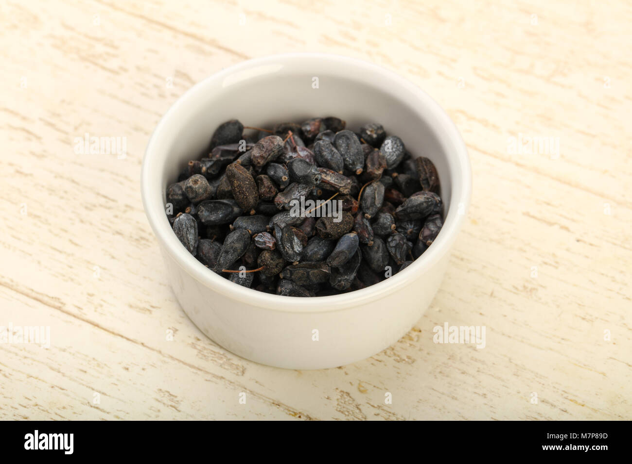 Dry barberry in the bowl over wooden background Stock Photo - Alamy