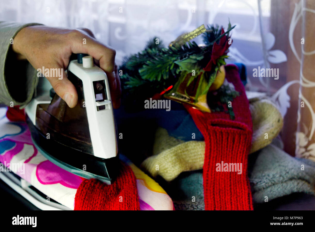 Closeup indoor shot of a man ironing socks and towels Stock Photo - Alamy