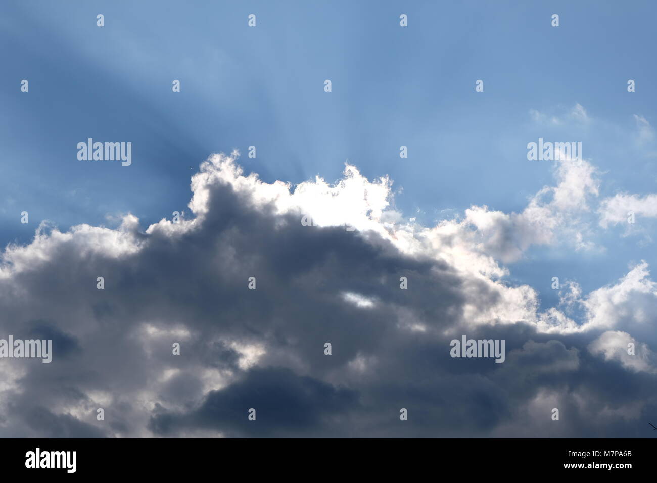 Sun streaming over clouds Stock Photo - Alamy