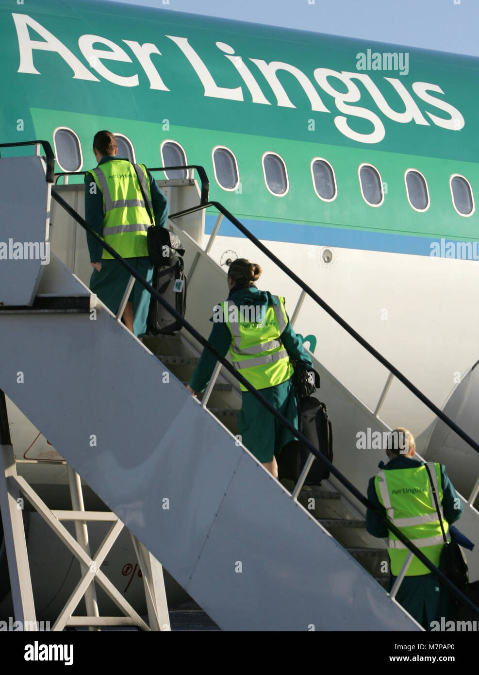 Cabin crew smile as they perpare to board their Cabin crew board their ...