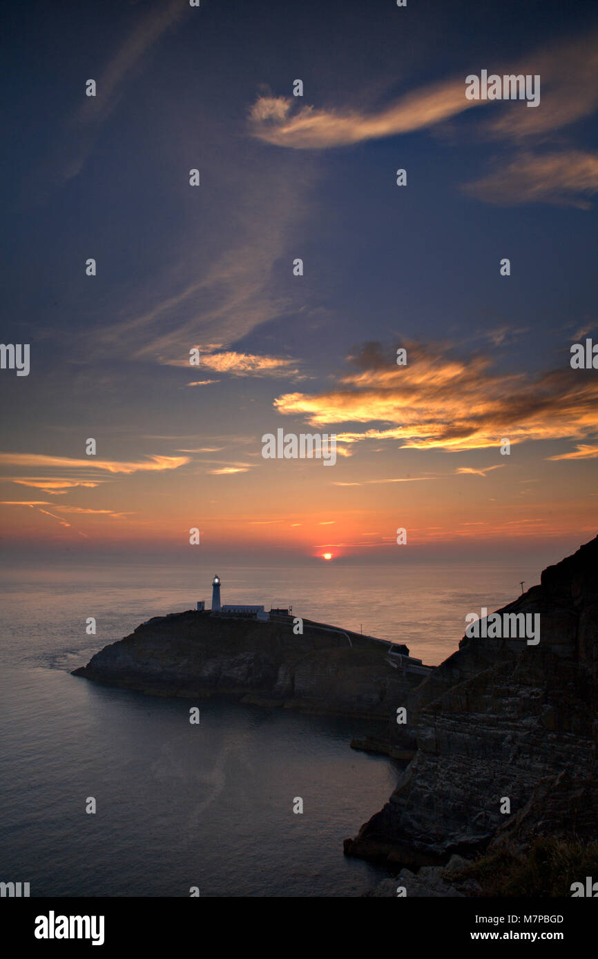 South Stack lighthouse at sunset, Anglesey, North Wales with sun ...