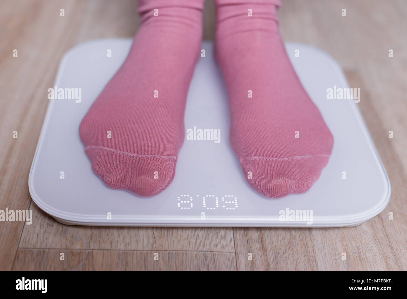 woman measuring her weight on a modern smart scales Stock Photo - Alamy