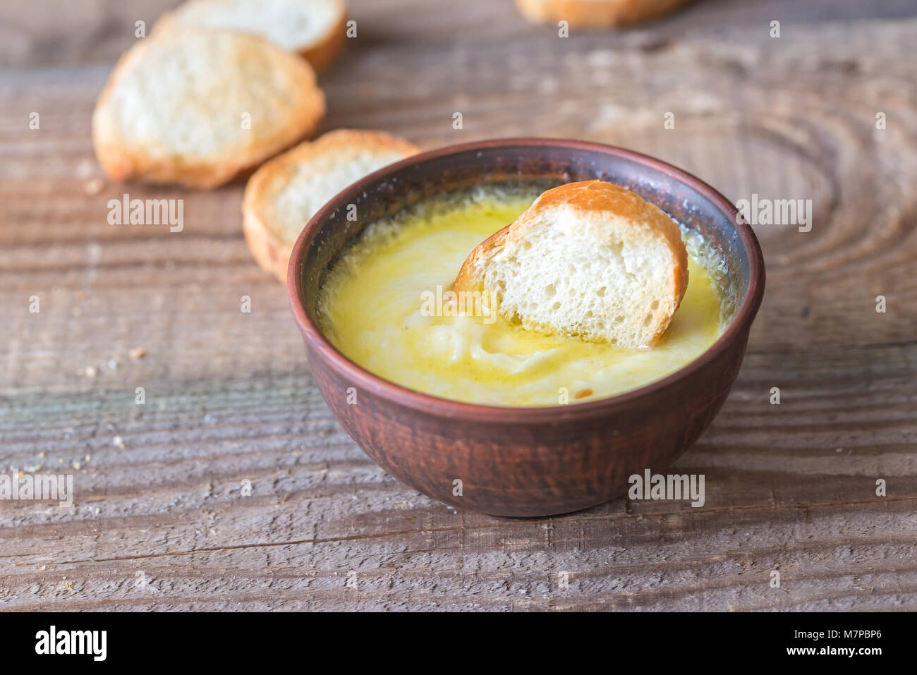 Bowl of cheese dip with toasts Stock Photo - Alamy