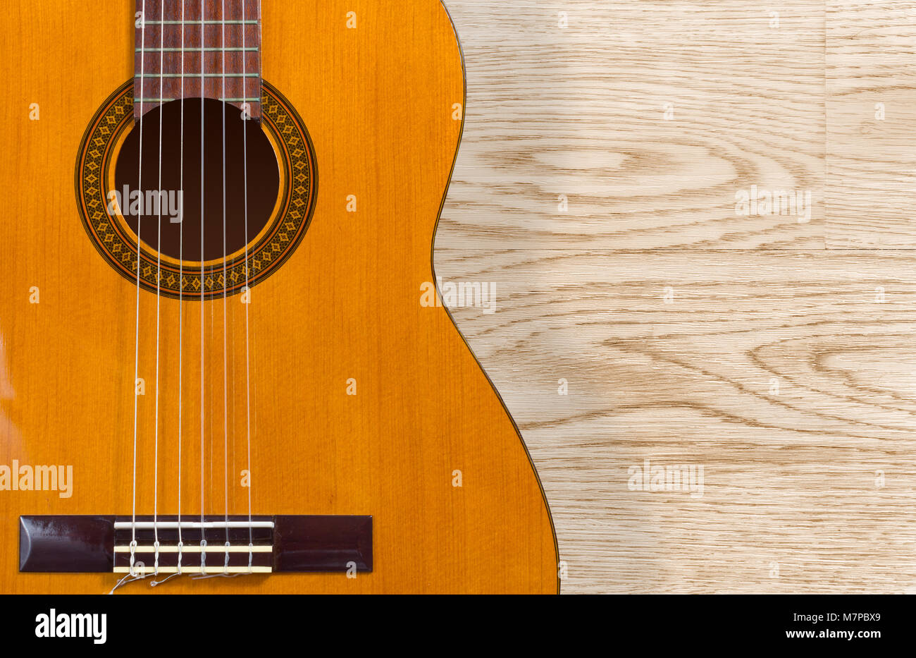 Classical guitar over a wood texture background Stock Photo - Alamy