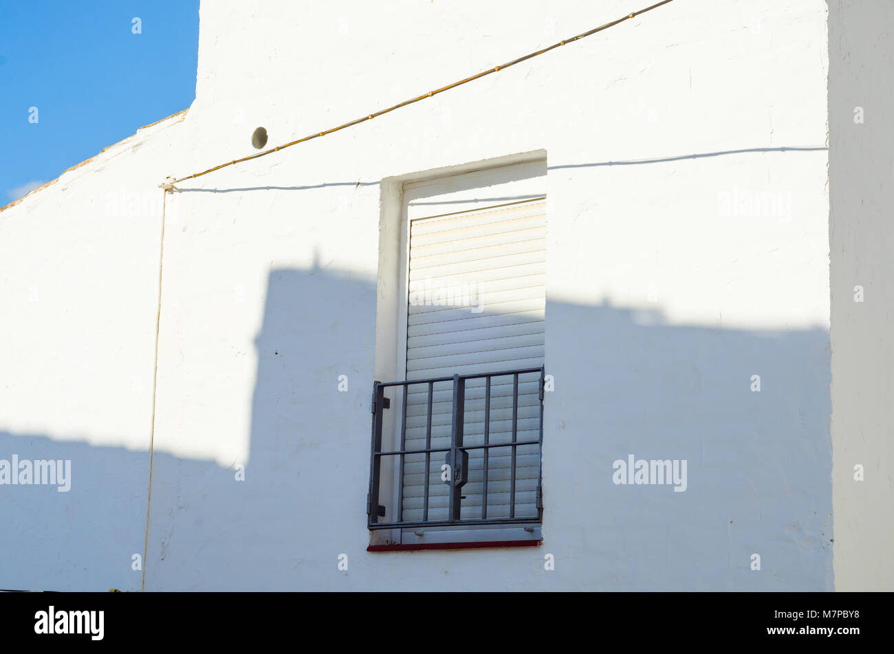 Stylish balcony with a metal railing, solid architectural element, a ...