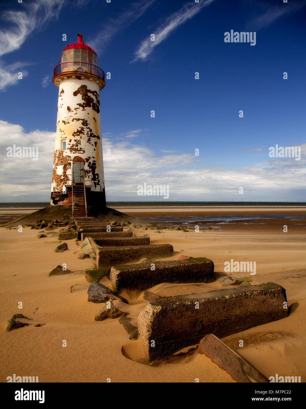 Derelict Point of Ayr lighthouse with decaying concrete path on Talacre ...