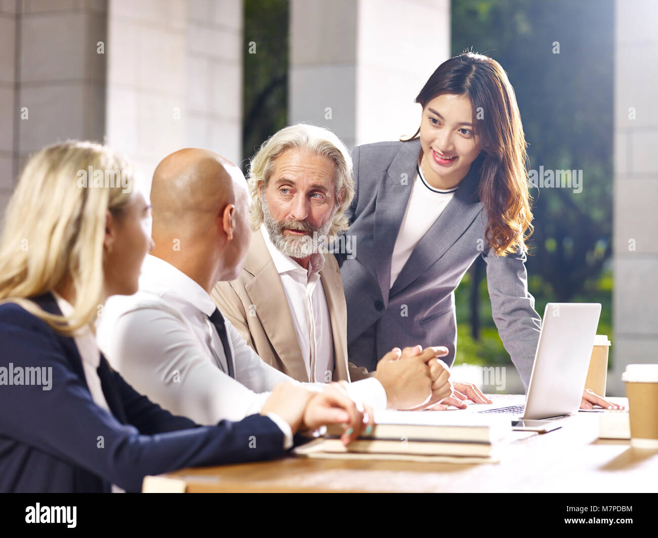 multiethnic corporate people meeting discussing business using laptop ...