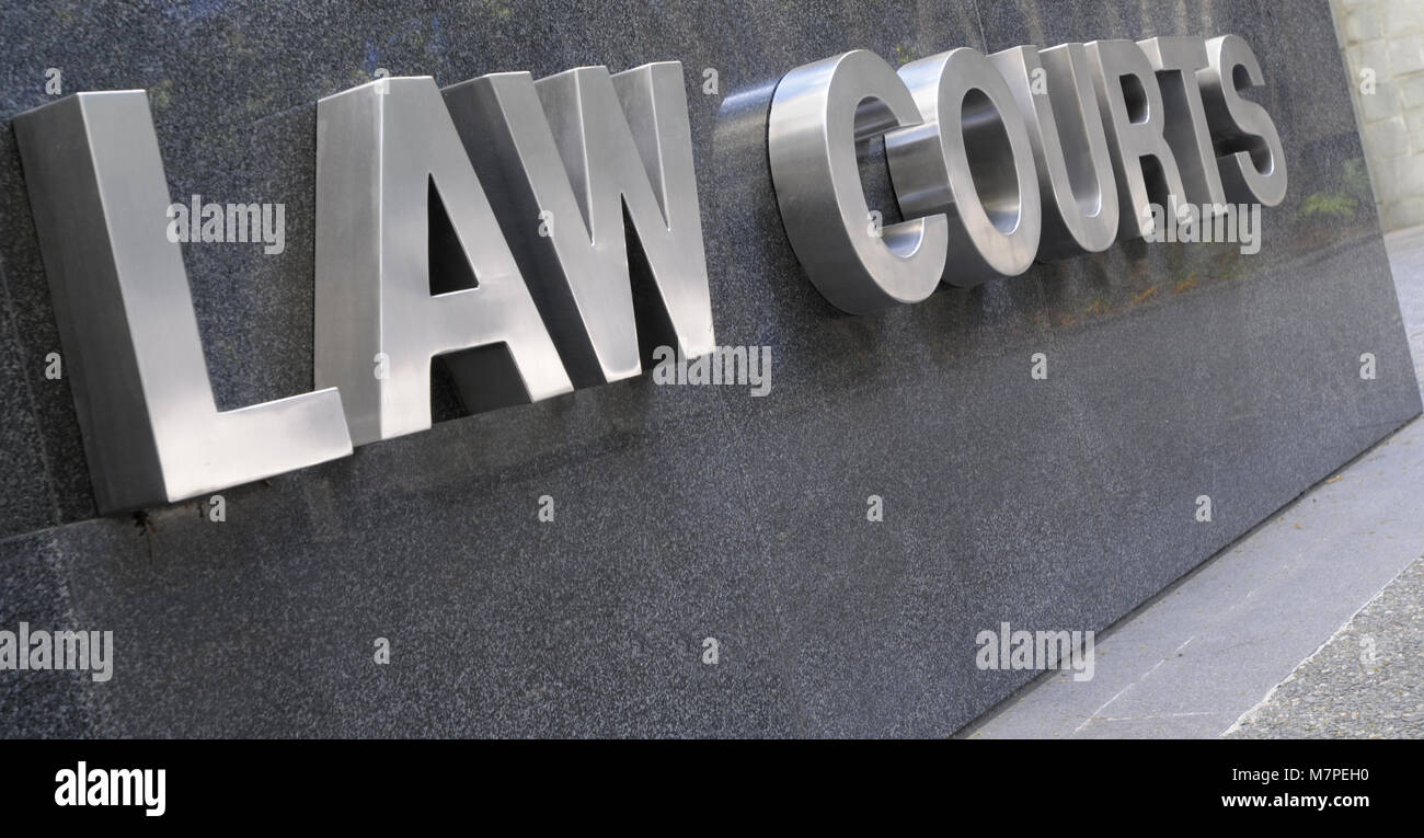 Law Courts sign in stainless steel against black marble Stock Photo - Alamy