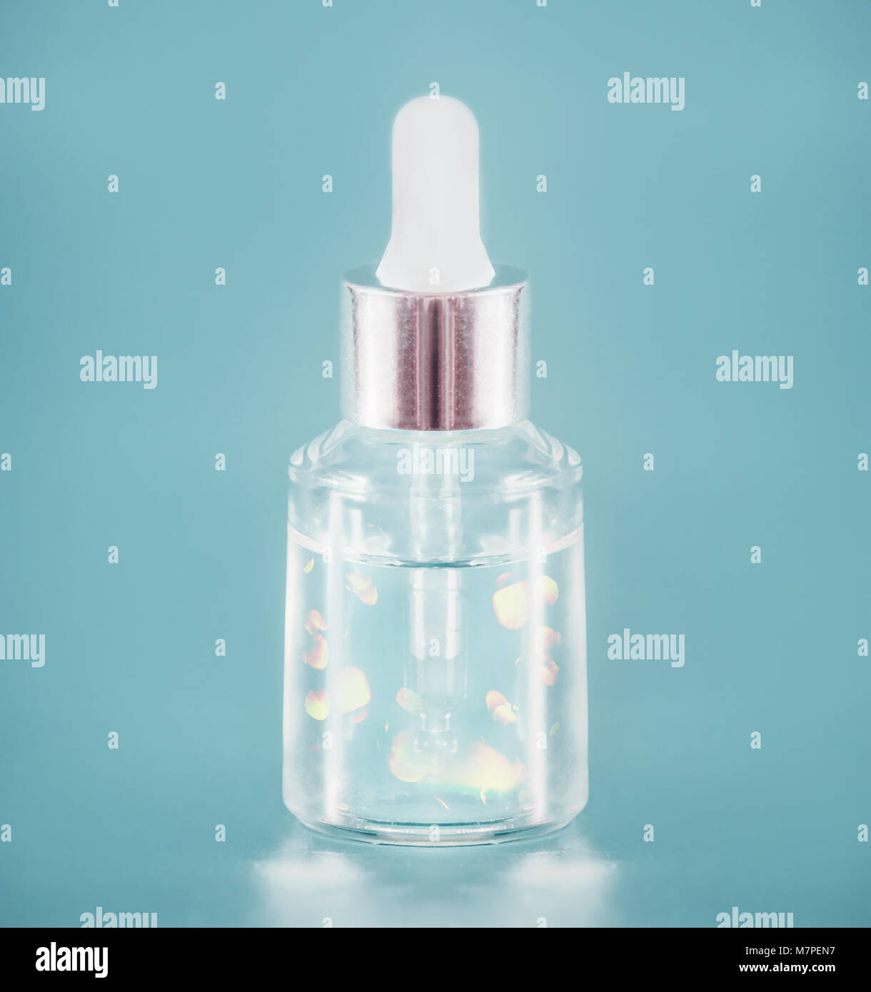 Cosmetic transparent liquid product in glass bottle with dropper. Gold ...