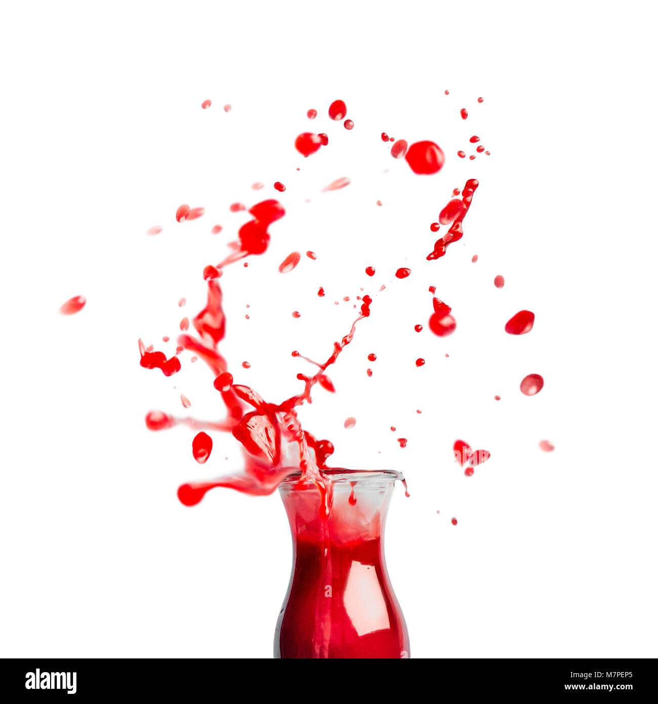 Red juice or smoothie glass bottle with splash, isolated on white ...