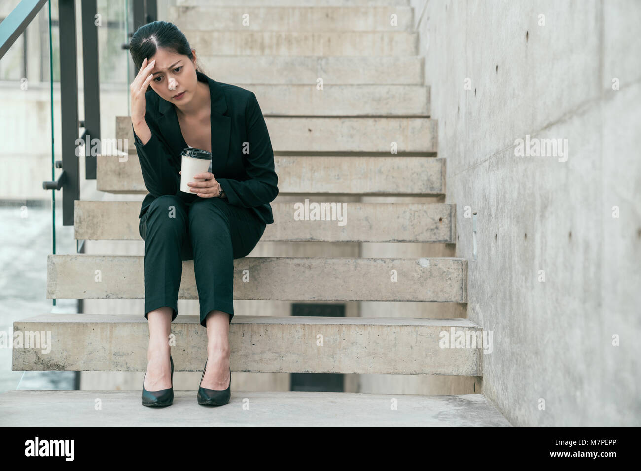 sad business girl sitting on the stairs tired from work Stock Photo - Alamy