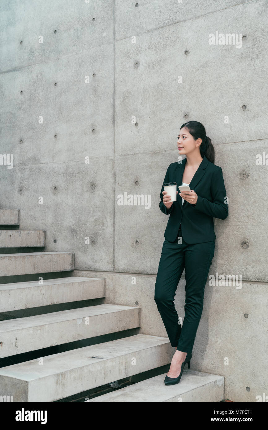 young successful business manager standing outside of office stair ...