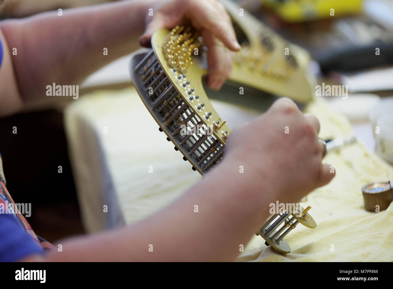 St. Petersburg, Russia - August 8, 2017: Worker making harp in ...