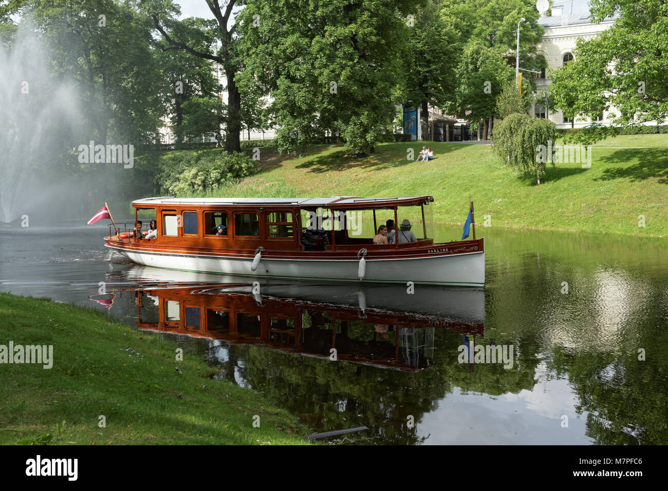 Riga, Latvia - June 18, 2017: People on the tour boat in city canal ...