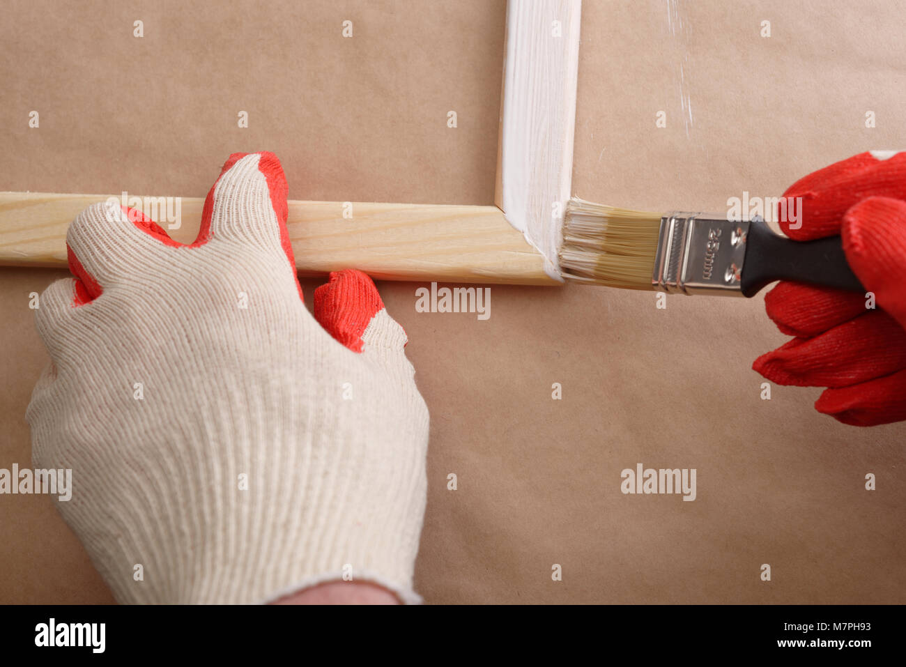 Painting a wooden frame in white color Stock Photo - Alamy