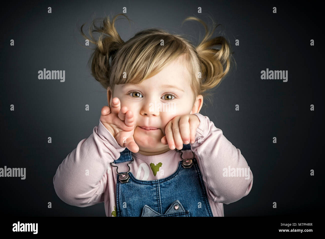 fun portrait of cute femail child pose in studio Stock Photo - Alamy