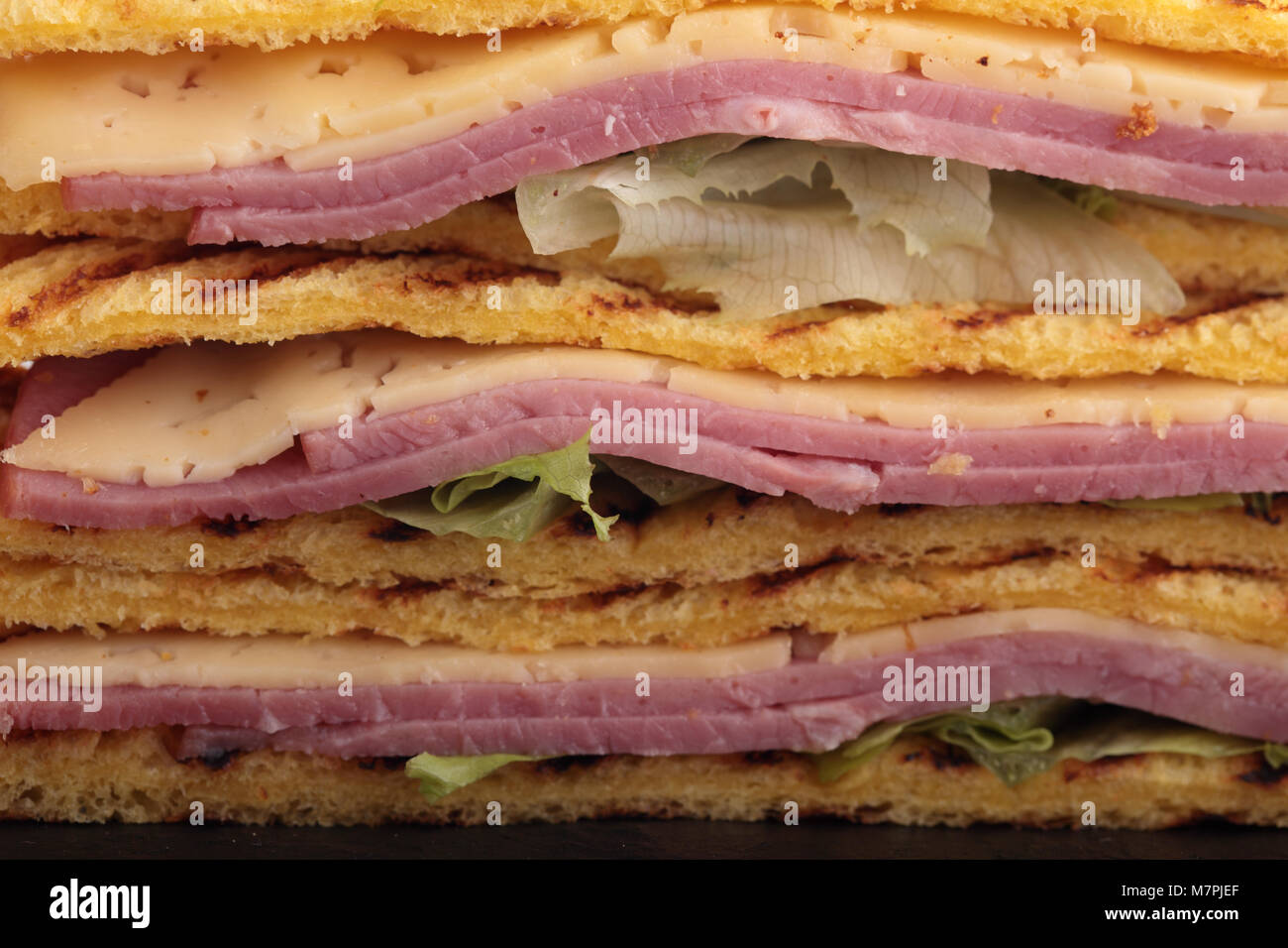 Background image of stack of sandwiches with ham, cheese, lettuce, and ...