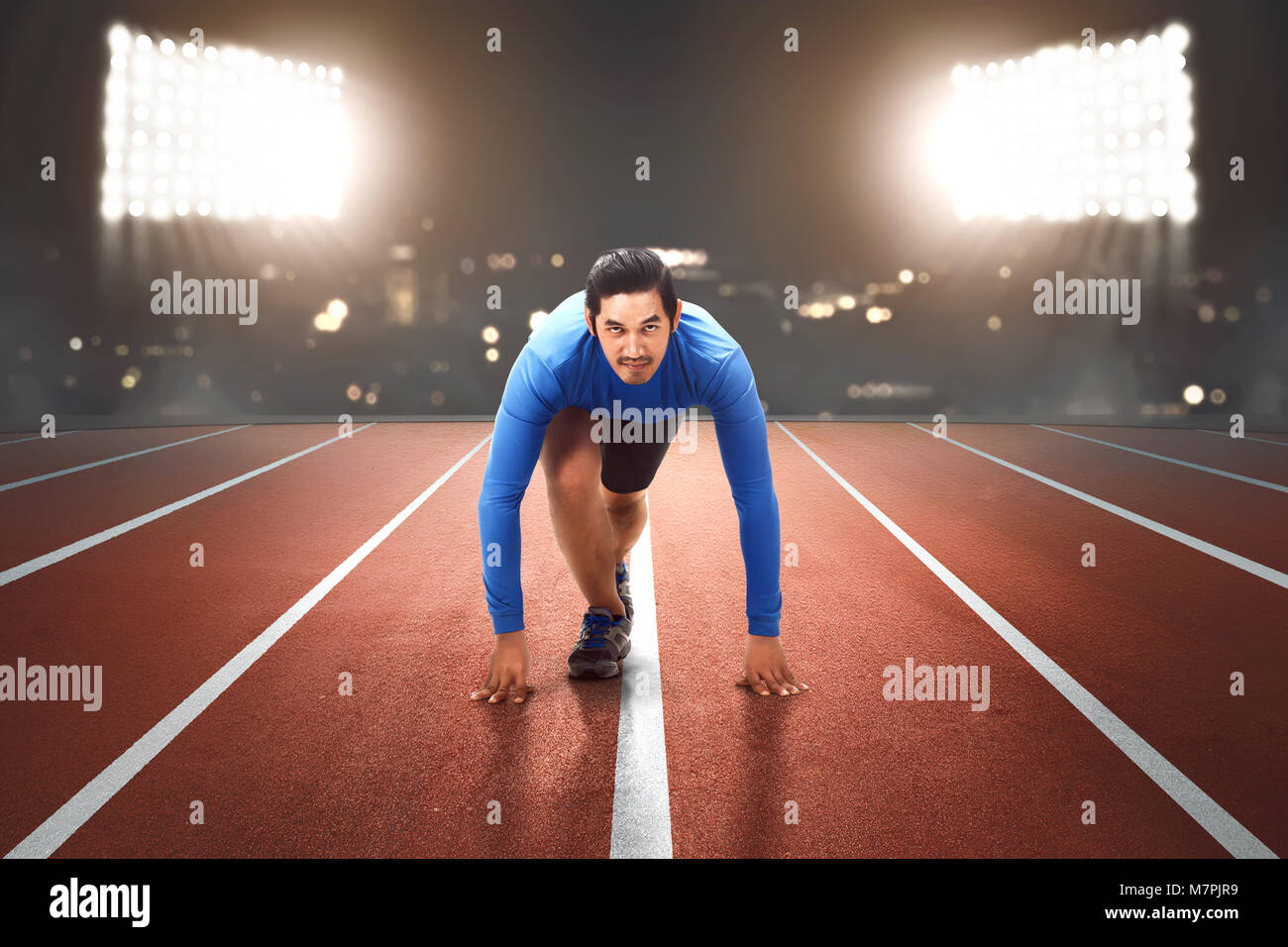 Young asian runner ready to running in the start position Stock Photo ...