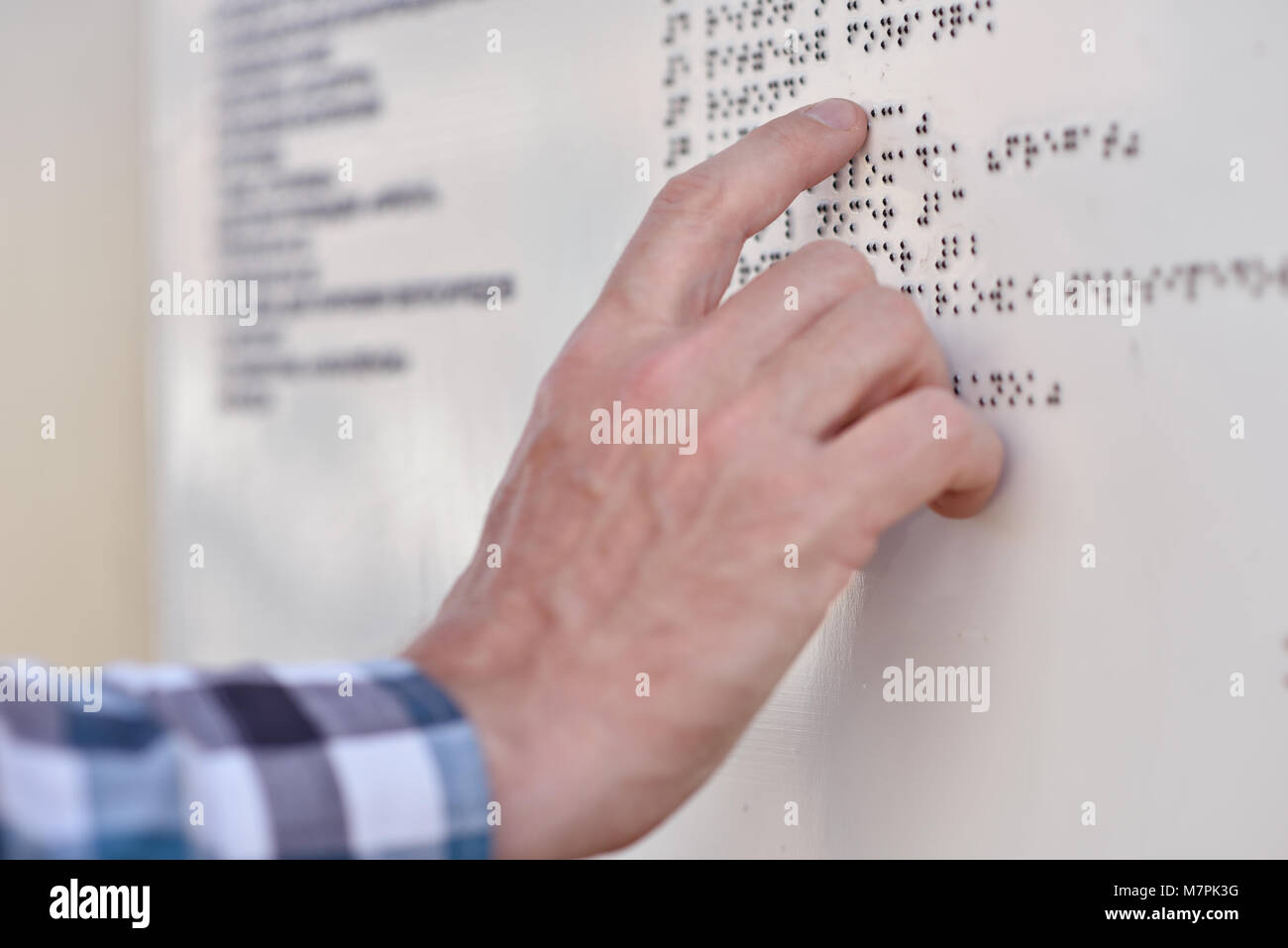 Man reading the Braille plate Stock Photo - Alamy