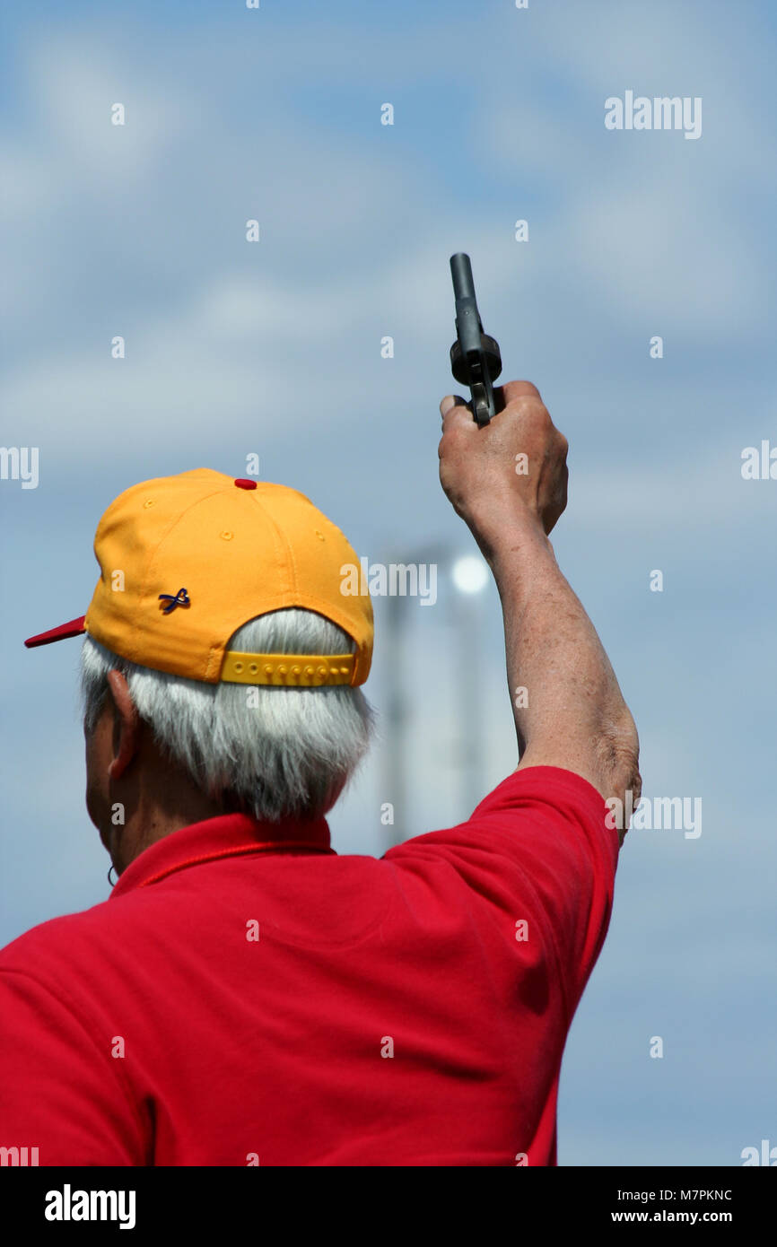 Man with starting gun Stock Photo - Alamy