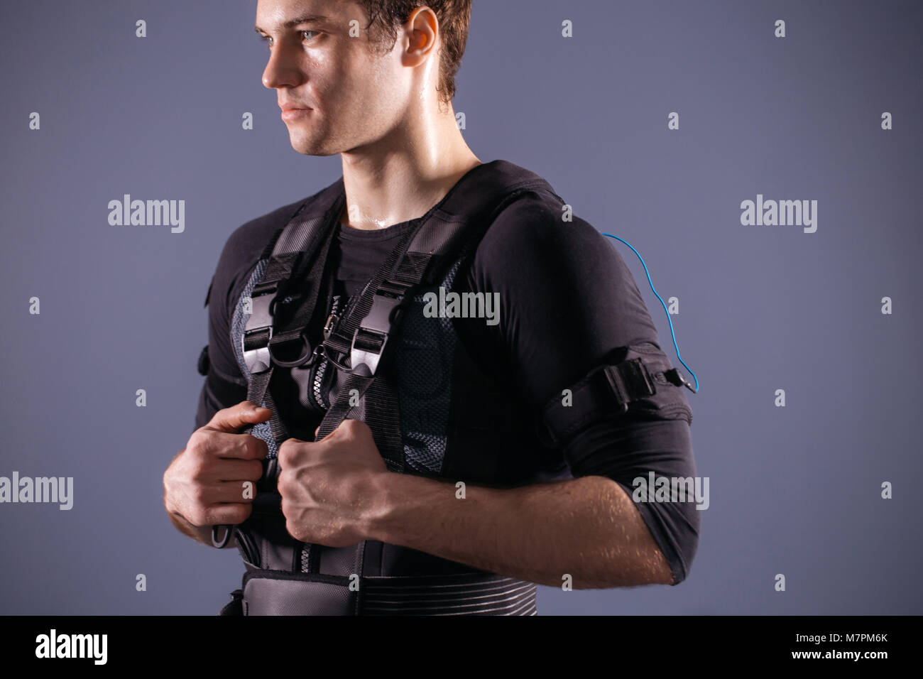 portrait of handsome man wearing ems suit near electro muscle ...