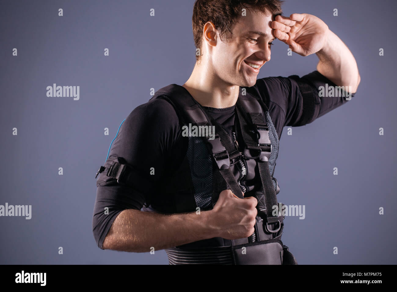 Tired sportsman wipes sweat after training with ems Stock Photo - Alamy