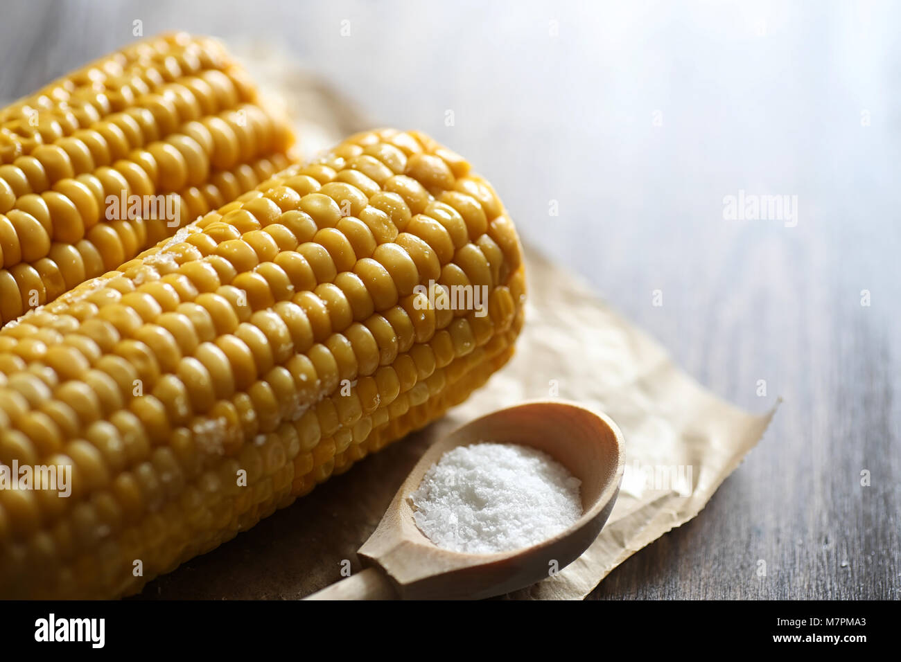Boiled corn cob with salt on a wood Stock Photo - Alamy