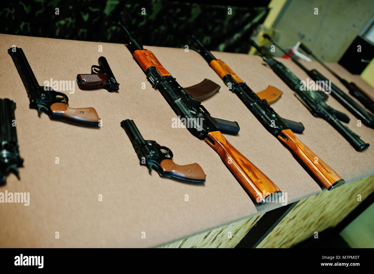 Different machine guns and gun revolvers on shooting range Stock Photo ...