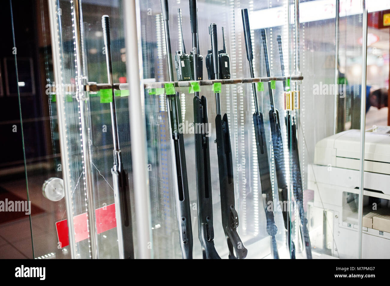 Different rifles on shelves store weapons on shop center Stock Photo ...