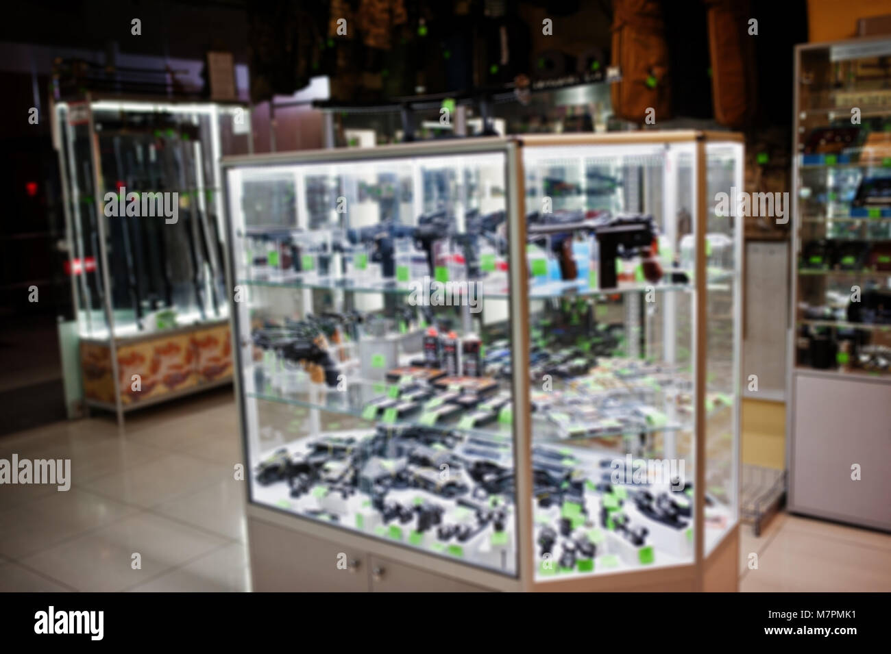 Blur photo of shelves store weapons on shop center Stock Photo - Alamy