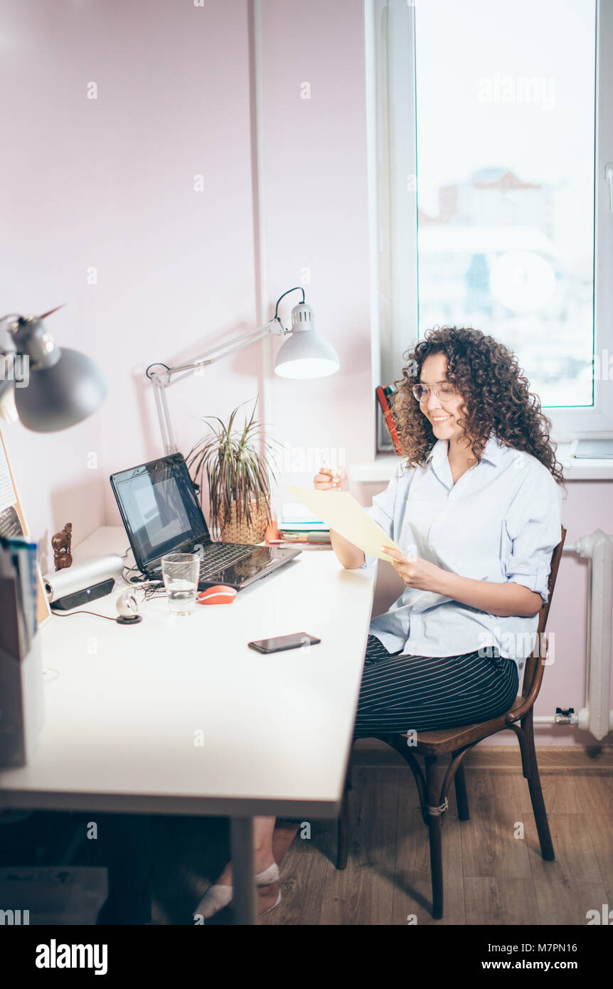 young Caucasian woman in happy mood writing happy evvents of her ...