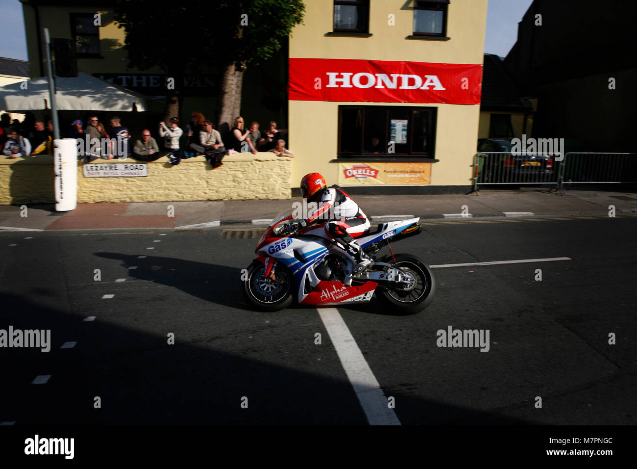 A TT racer travels through Ramsey. The 100 Centenary TT Races on the ...