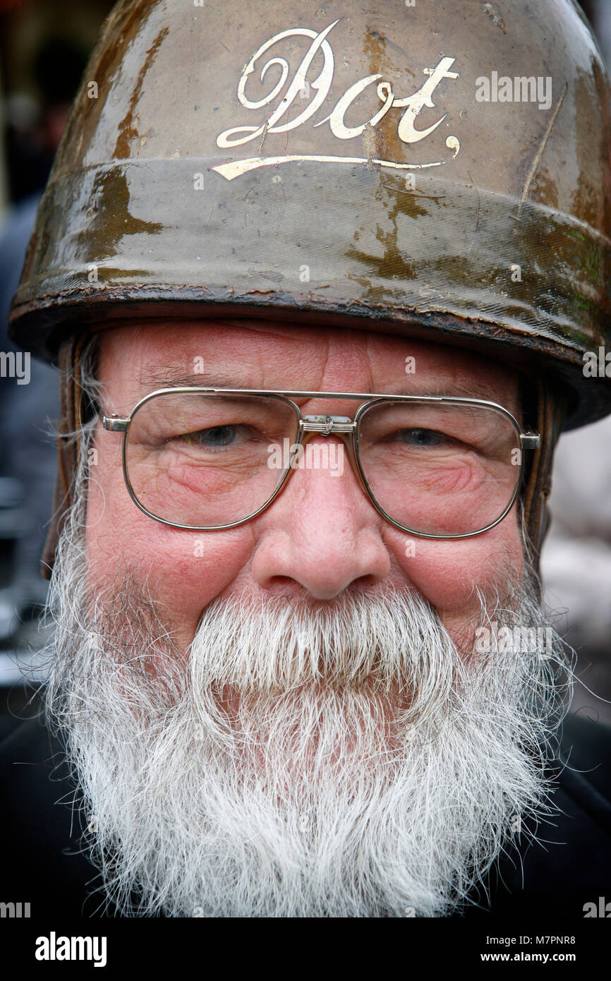 A veteran motorbiker taking part in a vinage motorbike parade in ...