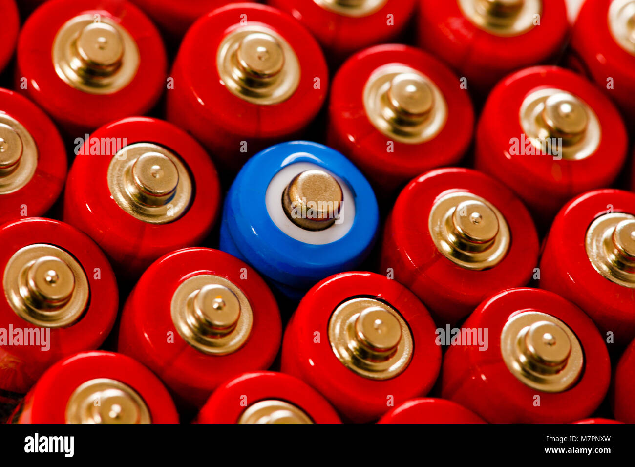 A lone blue AA battery amongst remaining red batteries Stock Photo - Alamy