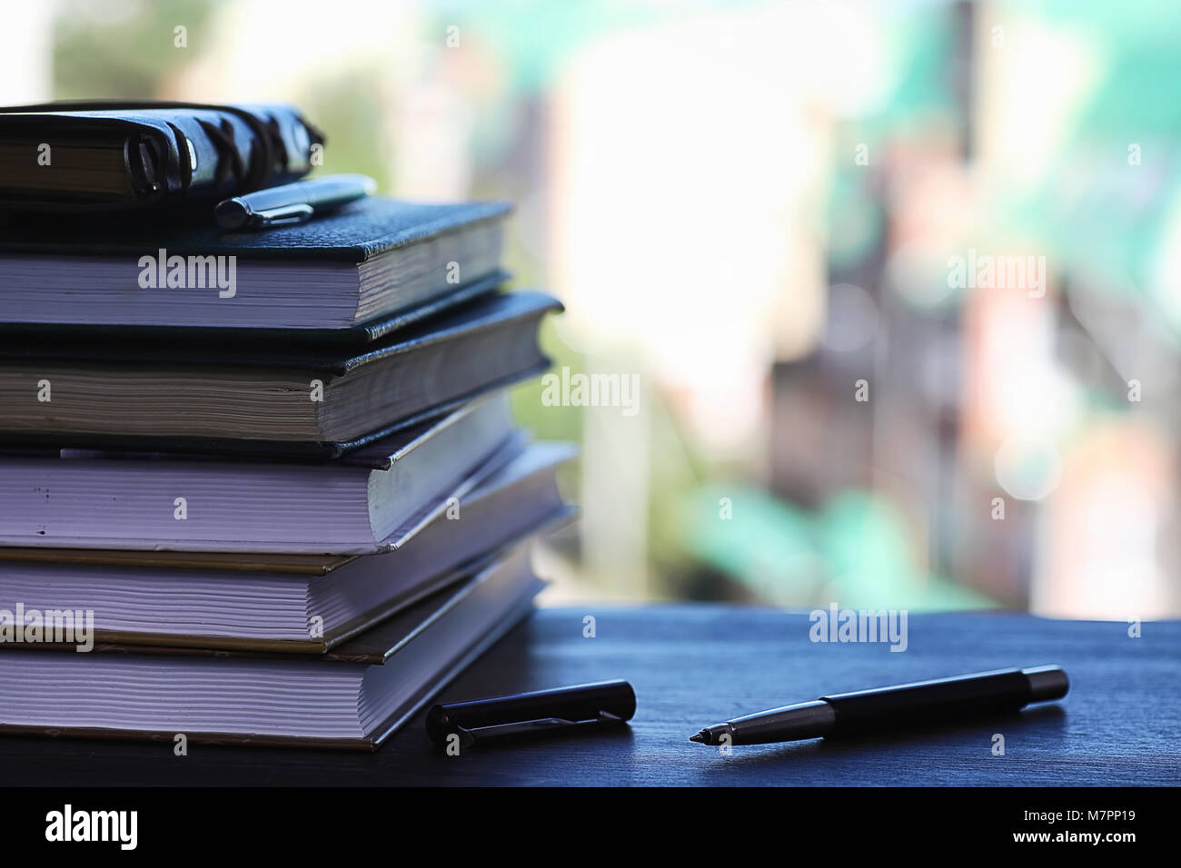 A stack of textbooks on the windowsill Stock Photo - Alamy