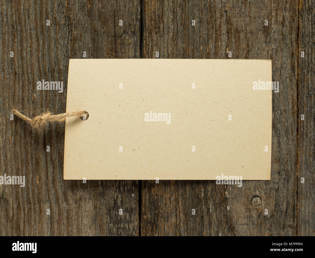 Paper notes on rope on wooden background. Copy space Stock Photo - Alamy