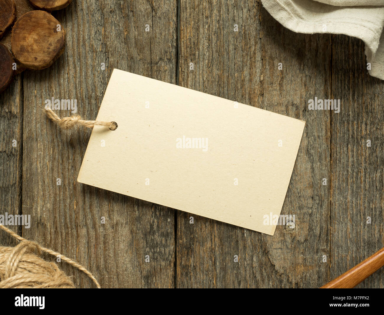 Paper notes on rope on wooden background. Copy space Stock Photo - Alamy