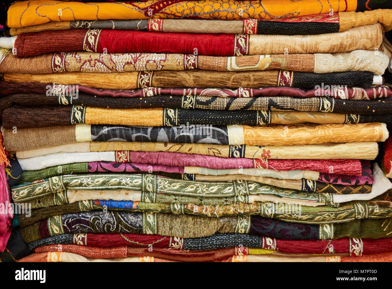 Pile of colorful folded textile. Heap of cloth fabric Stock Photo - Alamy